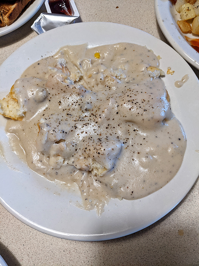 Biscuits and gravy that could settle family feuds&mdash;creamy, peppery gravy cascading over fluffy biscuits in a plate that screams "good morning, America!"