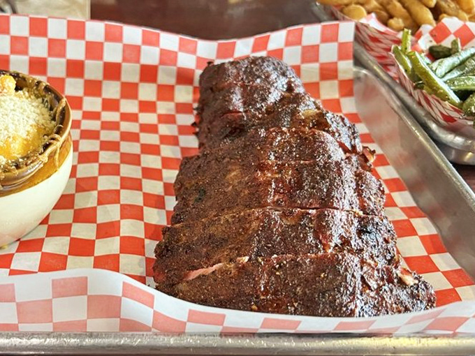 Baby back ribs with a bark so perfect it should be hanging in a barbecue hall of fame. The glaze catches light like carnivore's stained glass. 
