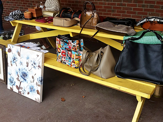 A yellow bench showcasing bags with personalities as diverse as their former owners. That comic book tote is practically screaming "take me home!"