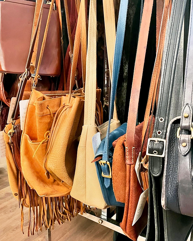 Leather bags in every shade of caramel and cognac hang like ripening fruit, each one aged to that impossible-to-manufacture patina that only time can create.