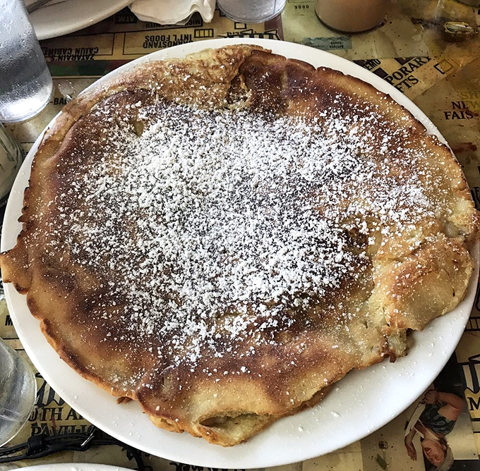 This pancake is what happens when a cloud and a cake have a delicious baby, dusted with powdered sugar and ready for its Instagram moment.