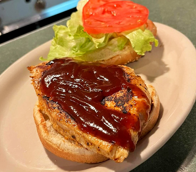 Not your average chicken sandwich. That barbecue sauce glistens with promise, while the bun stands ready for its supporting role in your lunch happiness.