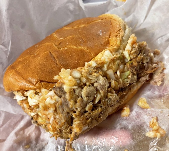 The perfect barbecue sandwich: a soft bun cradling chopped pork and slaw in perfect harmony, like a meat-and-bread symphony composed by Southern angels.