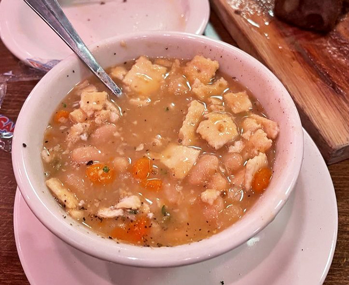 The legendary Senate Bean Soup, swimming with chunks of ham and vegetables, proves that humble ingredients can create diplomatic relations between your taste buds.