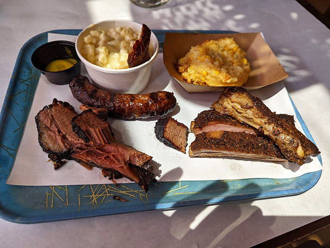 BBQ nirvana on a blue tray: brisket with that perfect bark, ribs with the ideal bite, and sides that refuse to be overshadowed.