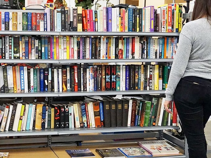 The book section is a literary roulette wheel where dog-eared bestsellers share shelf space with forgotten classics and unexpected first editions.