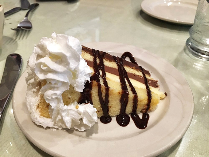 A slice of cake that understands the importance of proper whipped cream-to-cake ratio &ndash; this isn't dessert, it's architecture with a sweet tooth.