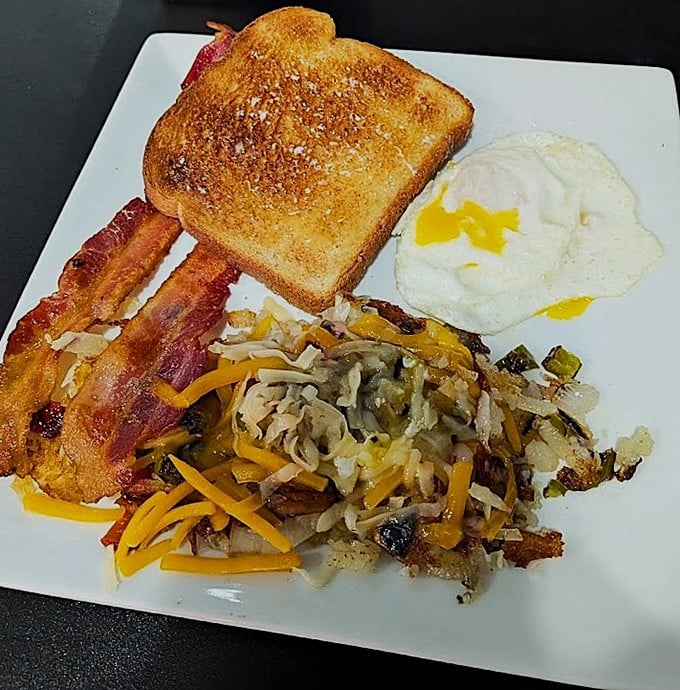 The classic breakfast trinity &ndash; perfectly cooked eggs, golden hash browns with that essential crispy exterior, and toast ready for its butter-melting destiny.