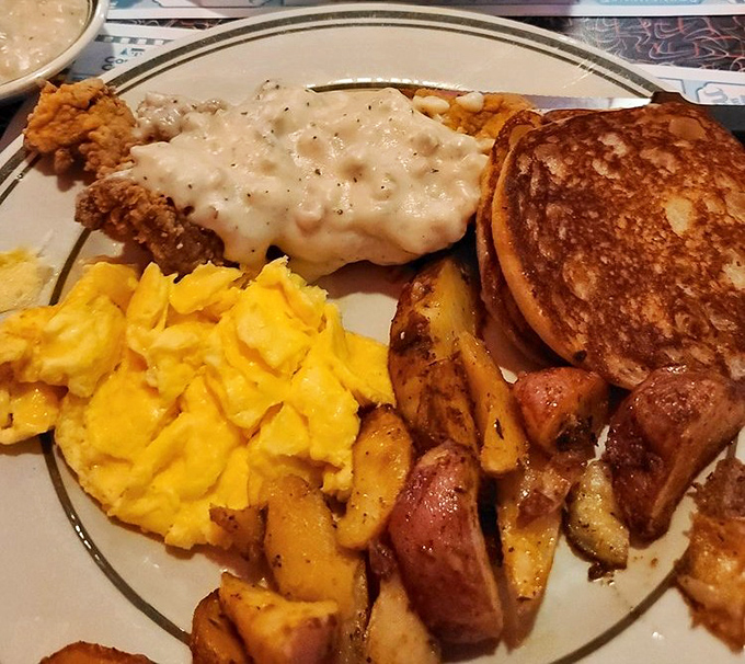 Breakfast nirvana achieved: golden home fries, scrambled eggs, and country fried steak smothered in gravy. The breakfast of champions who aren't counting calories.