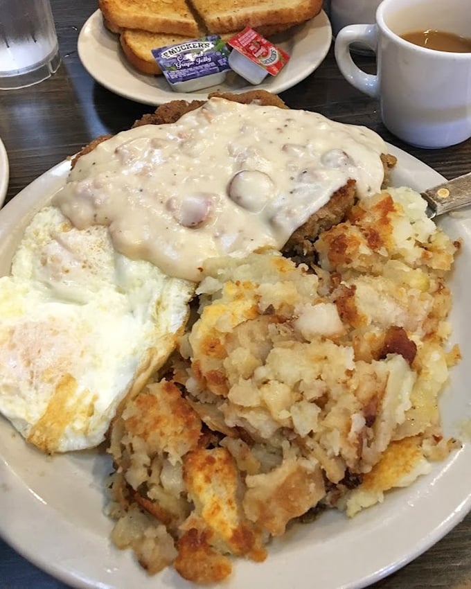 Breakfast architecture at its finest &ndash; crispy potatoes as the foundation, eggs for structure, and that gravy? Pure delicious rooftop decadence.