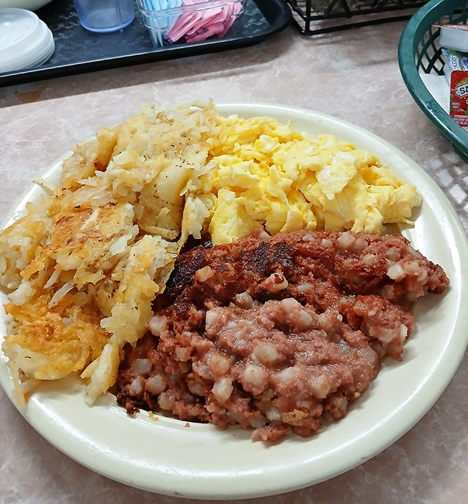 The breakfast trinity: perfectly scrambled eggs, hash browns with the ideal crisp-to-tender ratio, and country ham that means business.
