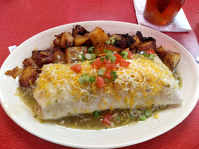 The Eggarito isn't just wrapped—it's embraced by that tortilla, smothered in sauce and cheese like a breakfast burrito that won the lottery.