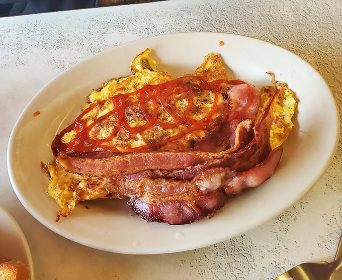 An omelet and bacon plate that answers the eternal question: "What would happiness look like if it were breakfast?"