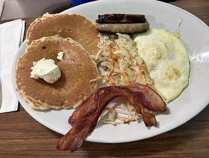 Pancakes, eggs, bacon, sausage, and hash browns &ndash; this breakfast plate doesn't believe in holding back or counting calories. 