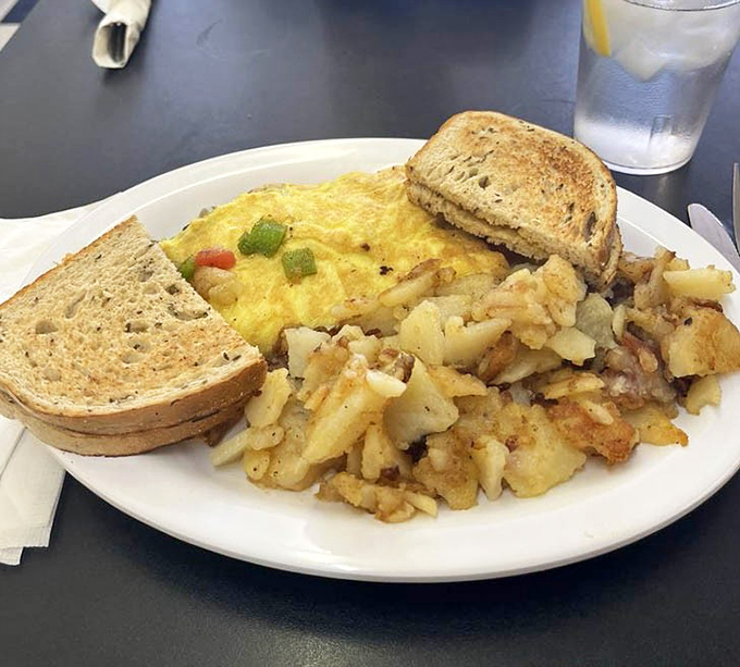 The breakfast trinity: perfectly scrambled eggs, home fries with that ideal crisp-tender balance, and toast ready for its butter-soaked destiny.