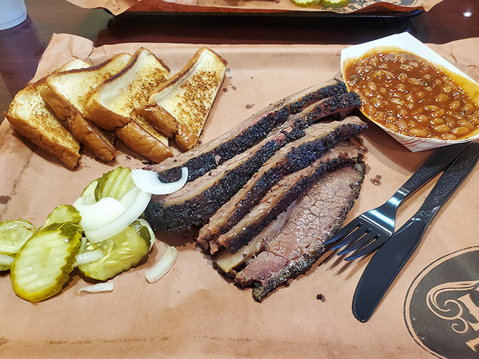 Brisket with a smoke ring so perfect it could be framed. The pickles aren't garnish &ndash; they're necessary acid to cut through that richness.