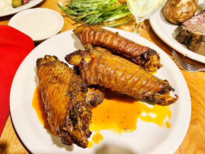 These wings aren't just cooked, they're transformed. Buffalo sauce glistening like amber jewelry on a plate.