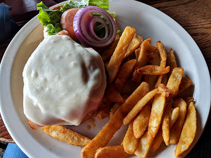 A burger that's melting with cheese and surrounded by golden fries &ndash; comfort food that speaks the universal language of "you're going to need a nap after this."