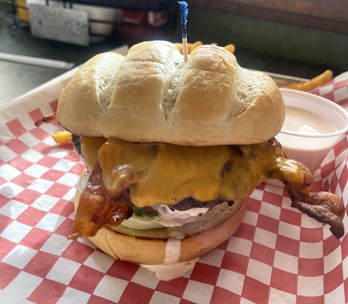 A burger that doesn't need fancy toppings to impress—just honest ingredients stacked high enough to make your jaw unhinge like a python.