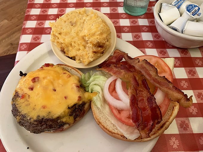 This isn't just a cheeseburger; it's a masterclass in comfort food, paired with hashbrown casserole that could make a grown person weep.
