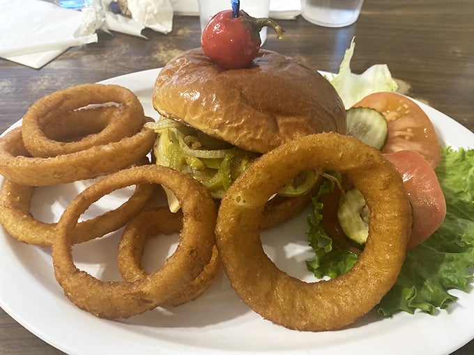 The burger and onion ring combo that makes you question why you ever waste calories on fancy food. Those rings are the golden halos of comfort food heaven.