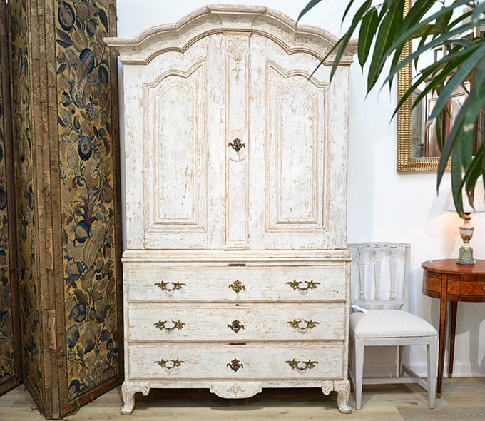 This distressed white armoire isn't just furniture&mdash;it's architectural salvation. Someone loved this piece enough to give it a second life.