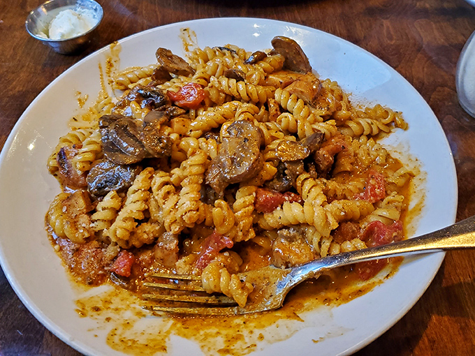 This pasta dish isn't just food&mdash;it's a colorful party where mushrooms, tomatoes, and sauce are having the time of their lives.