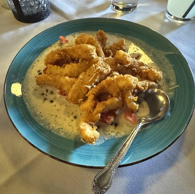 Crispy calamari swimming in a sea of creamy sauce. It's like the ocean's tastiest treasures decided to dress up for a night out in Indiana.