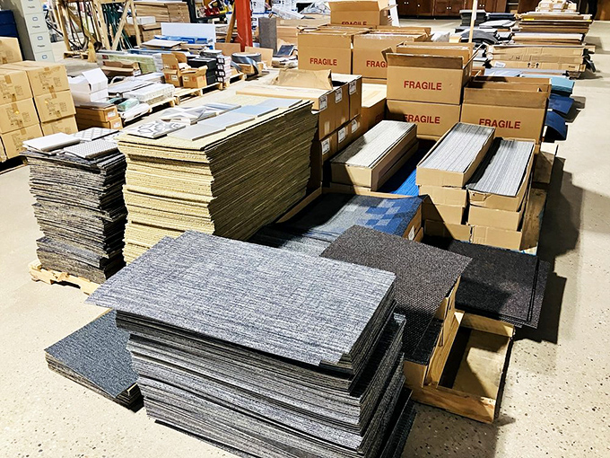 Carpet tiles stacked higher than my last credit card bill, but at a fraction of retail prices.