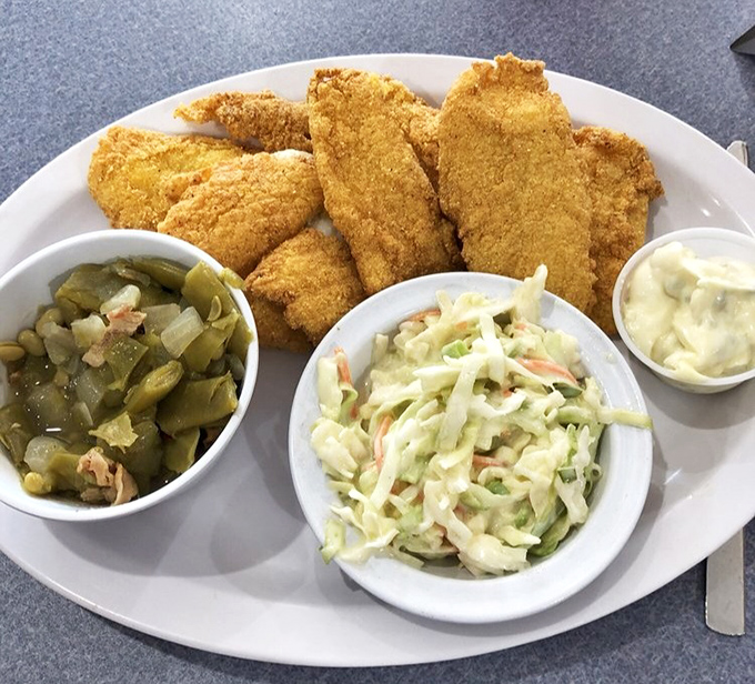 Southern-fried catfish with all the fixings &ndash; proof that simple food done right is the ultimate luxury. Crispy outside, tender within &ndash; perfection.