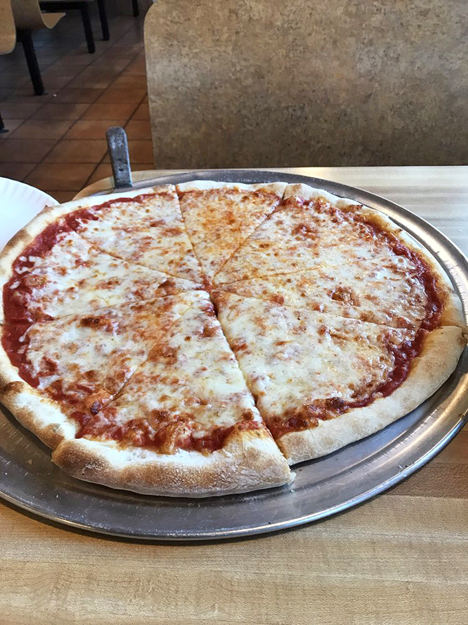 The classic cheese pizza that reminds you why simplicity often wins. That golden-brown crust edge deserves its own fan club.