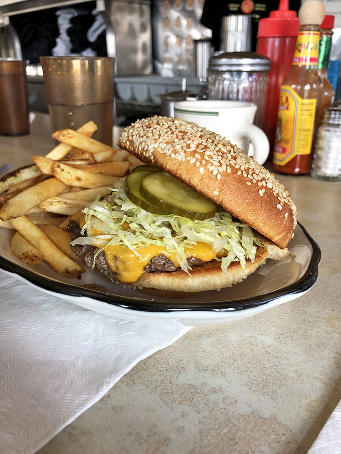 Behold the cheeseburger that launched a thousand road trips. That pickle isn't a garnish; it's the exclamation point on a perfect sentence.