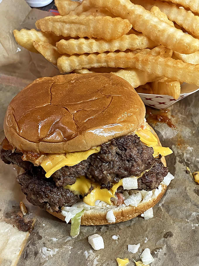 Two patties, melted cheese, and a toasted bun—this burger understands that more is definitely more when done right.
