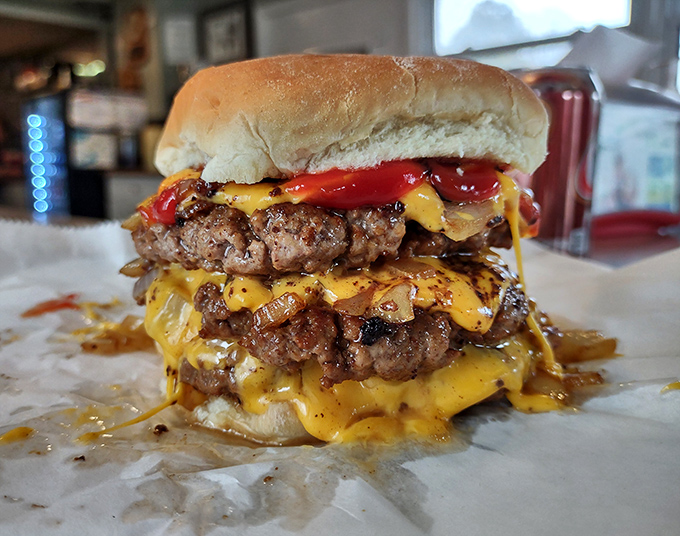Melted cheese cascading down perfectly seared patties like a yellow waterfall of joy. This isn't just a burger—it's performance art you can eat.