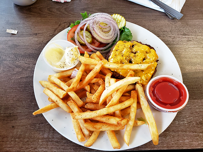 A burger that requires both hands and a strategy. The lettuce is just there to make you feel better about your choices.