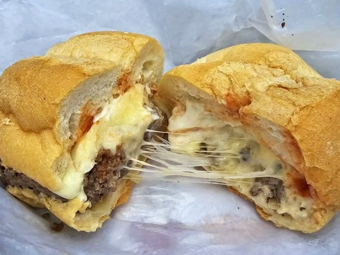 The money shot&mdash;cheese stretching like it's auditioning for a food commercial. This is what burger dreams are made of, folks.