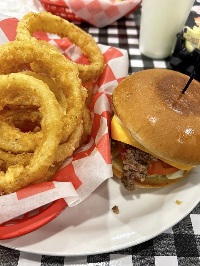 A burger and onion rings that remind you why simple food, done right, can outshine any fancy culinary trend. Those rings could double as delicious bracelets.