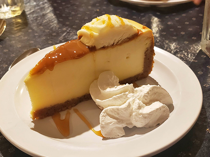 A slice of cheesecake that demands a moment of reverent silence. That caramel drizzle isn't just decoration&mdash;it's liquid gold.