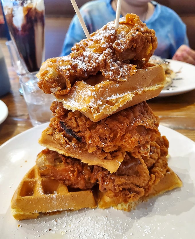 The chicken and waffle tower stands tall like the breakfast version of the Leaning Tower of Pisa, except this one's meant to topple directly into your mouth.
