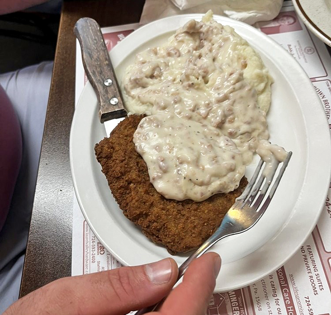 Chicken fried steak proving that sometimes breakfast needs to be taken seriously, very seriously.