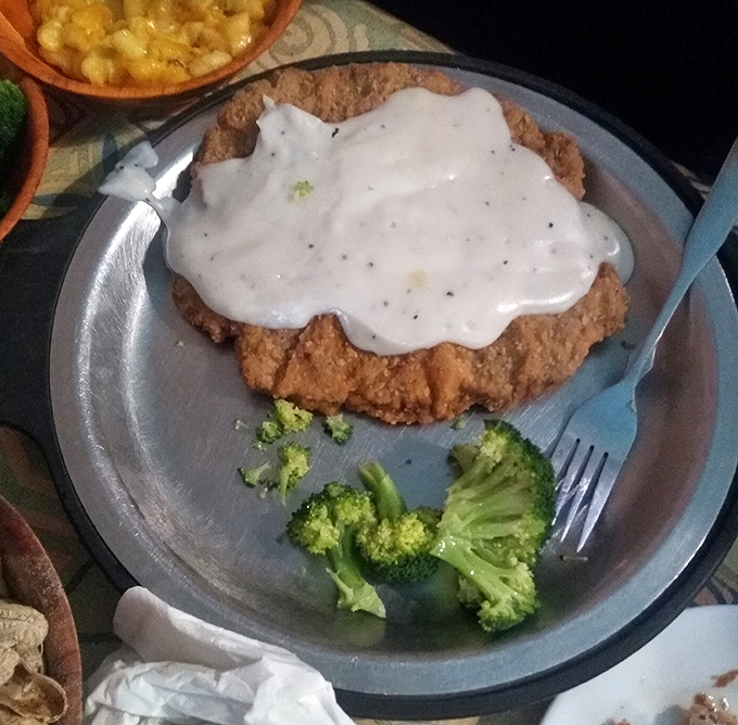 Country-fried steak smothered in creamy gravy&mdash;the kind of dish that makes you want to hug the chef and thank them for understanding comfort food on a spiritual level.