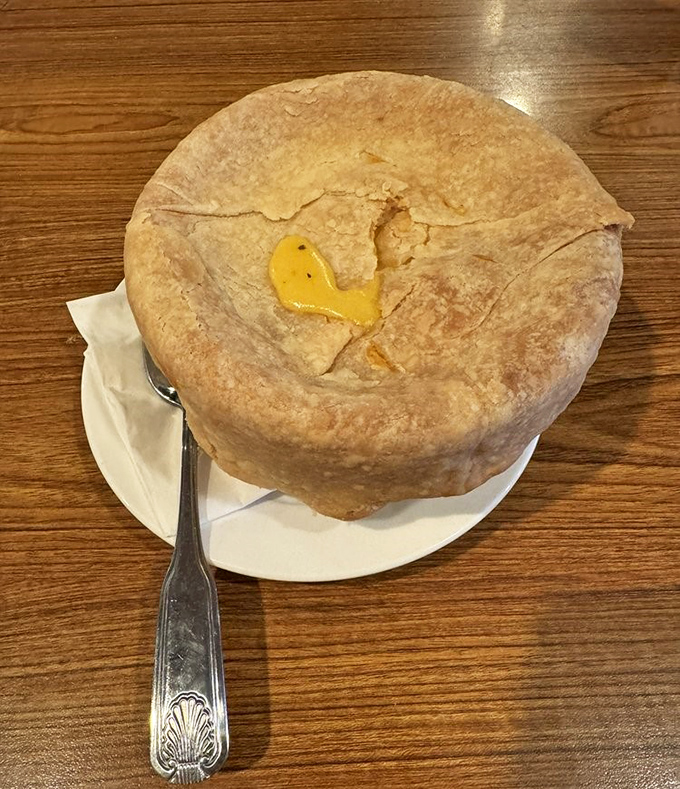 Beneath that golden crust lies a steaming chicken pot pie that could heal whatever ails you. Comfort food engineering at its finest.