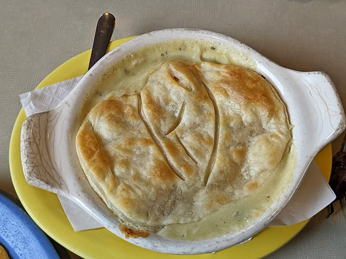 A chicken pot pie wearing a golden pastry hat &ndash; comfort food that whispers, "Everything's going to be alright" with every steaming spoonful.