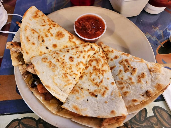 Not all quesadillas are created equal. This golden-grilled masterpiece with its side of salsa is proof that simple pleasures are often the most divine. 