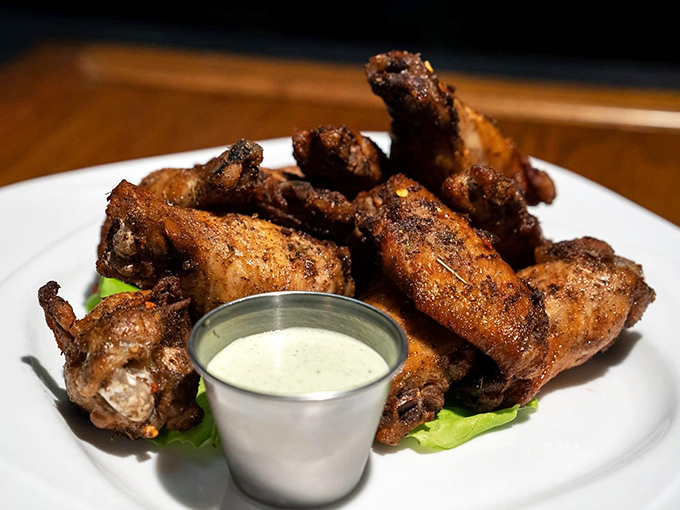 These chicken wings aren't messing around—crispy, seasoned to perfection, and served with cooling sauce. Finger food that's worth the extra napkins and potential shirt stains.