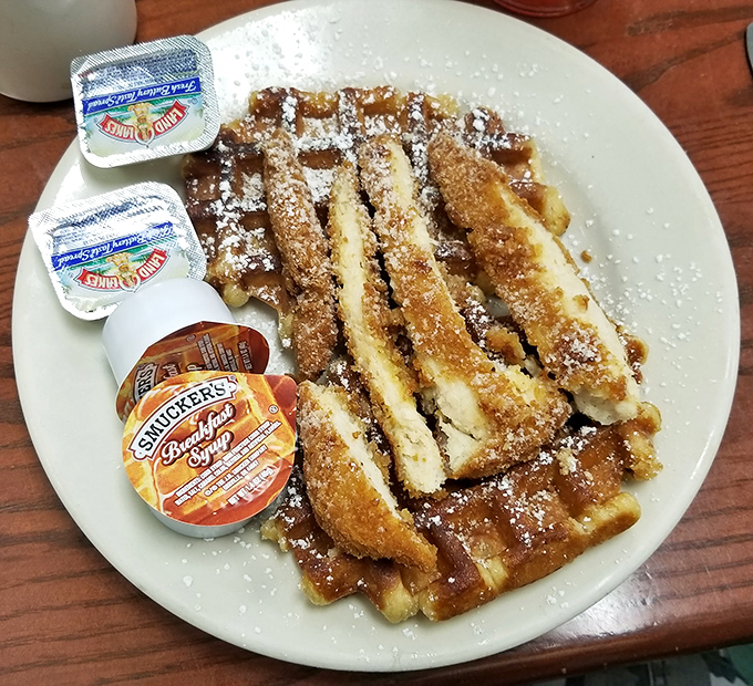 Chicken and waffles topped with fried eggs&mdash;because sometimes more is exactly what breakfast ordered, and who are we to argue?