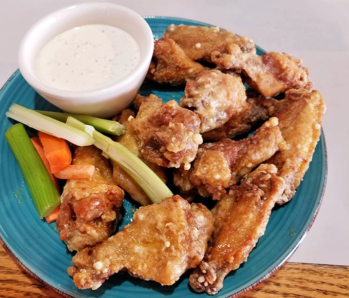 These wings arrive dressed for success, with celery standing by like a responsible designated driver for your taste buds.