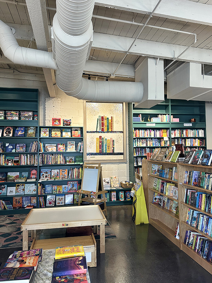 Exposed ductwork and industrial bones create the perfect contrast to the colorful worlds contained within these shelves.