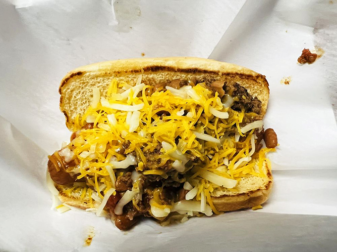 This isn't just a chili cheese dog; it's a beautiful mess of melted cheddar and homestyle chili that requires both hands and zero shame.