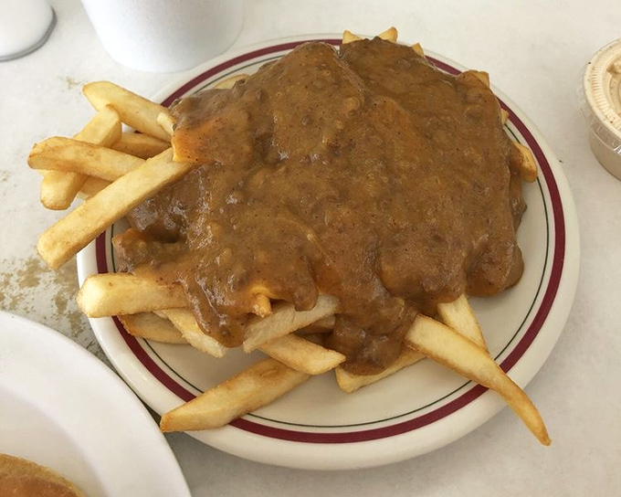 These fries aren't drowning in chili—they're swimming in flavor, creating a fork-required masterpiece that defies dainty eating.